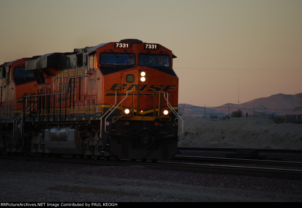BNSF 7331 starts to slow down for a crew swap at Dusk as she enters the BNSF Barstow yard.